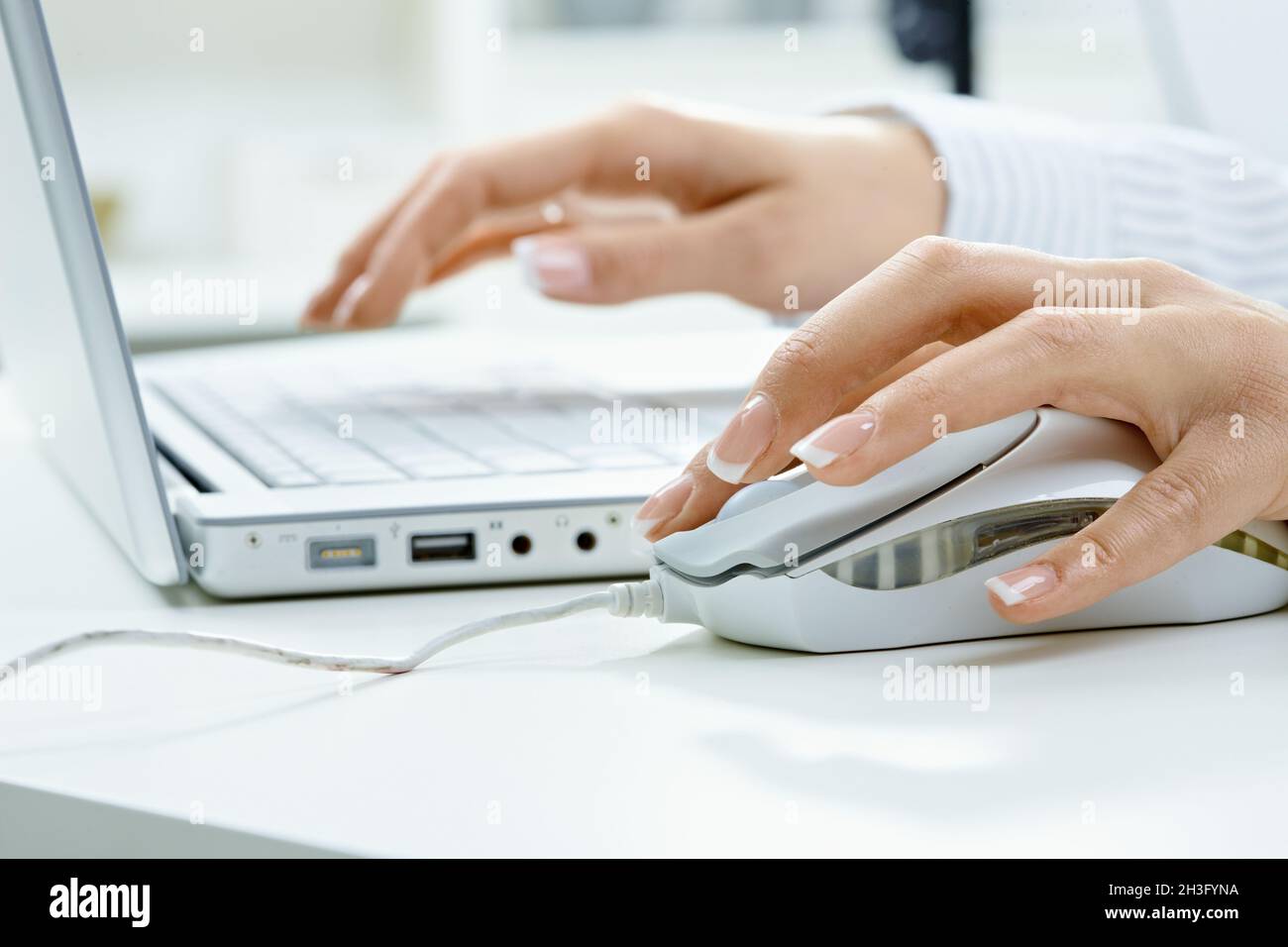 Female hand using computer mouse Stock Photo - Alamy