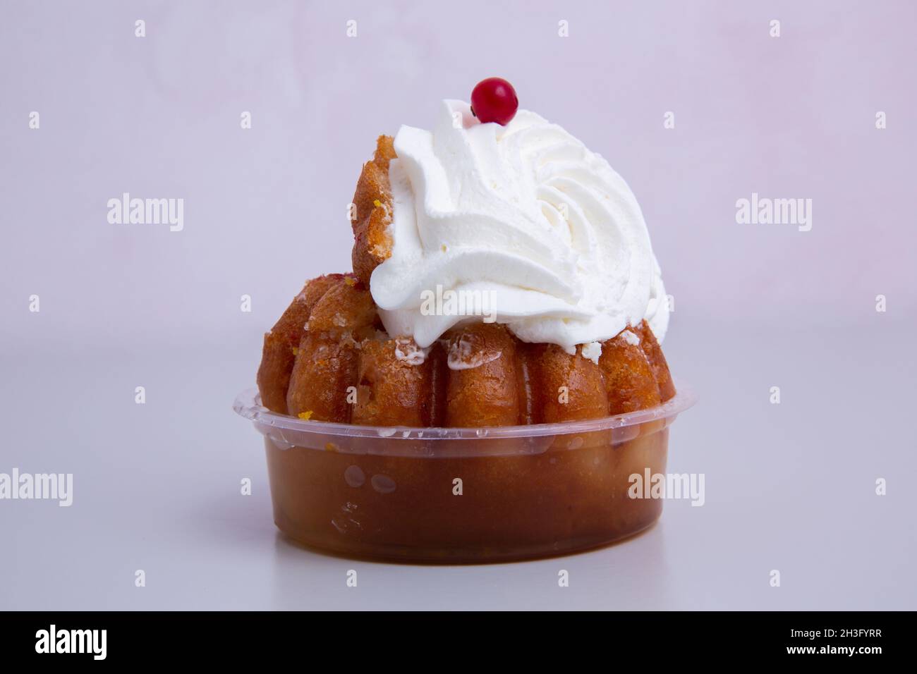 Closeup shot of a delicious rum baba cake on the white background Stock ...
