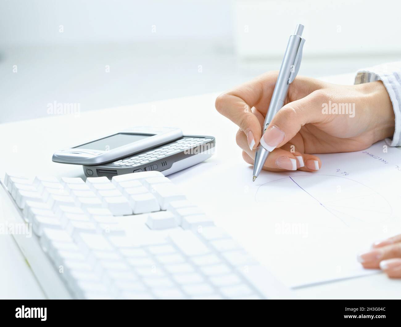 Female hand writing on paper Stock Photo - Alamy