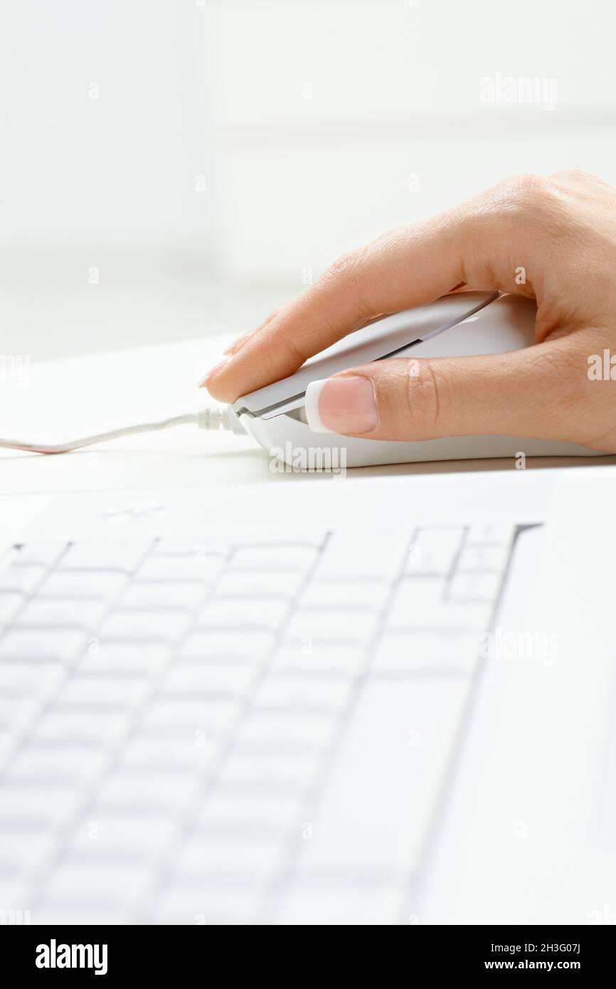 Female hand using computer mouse Stock Photo - Alamy