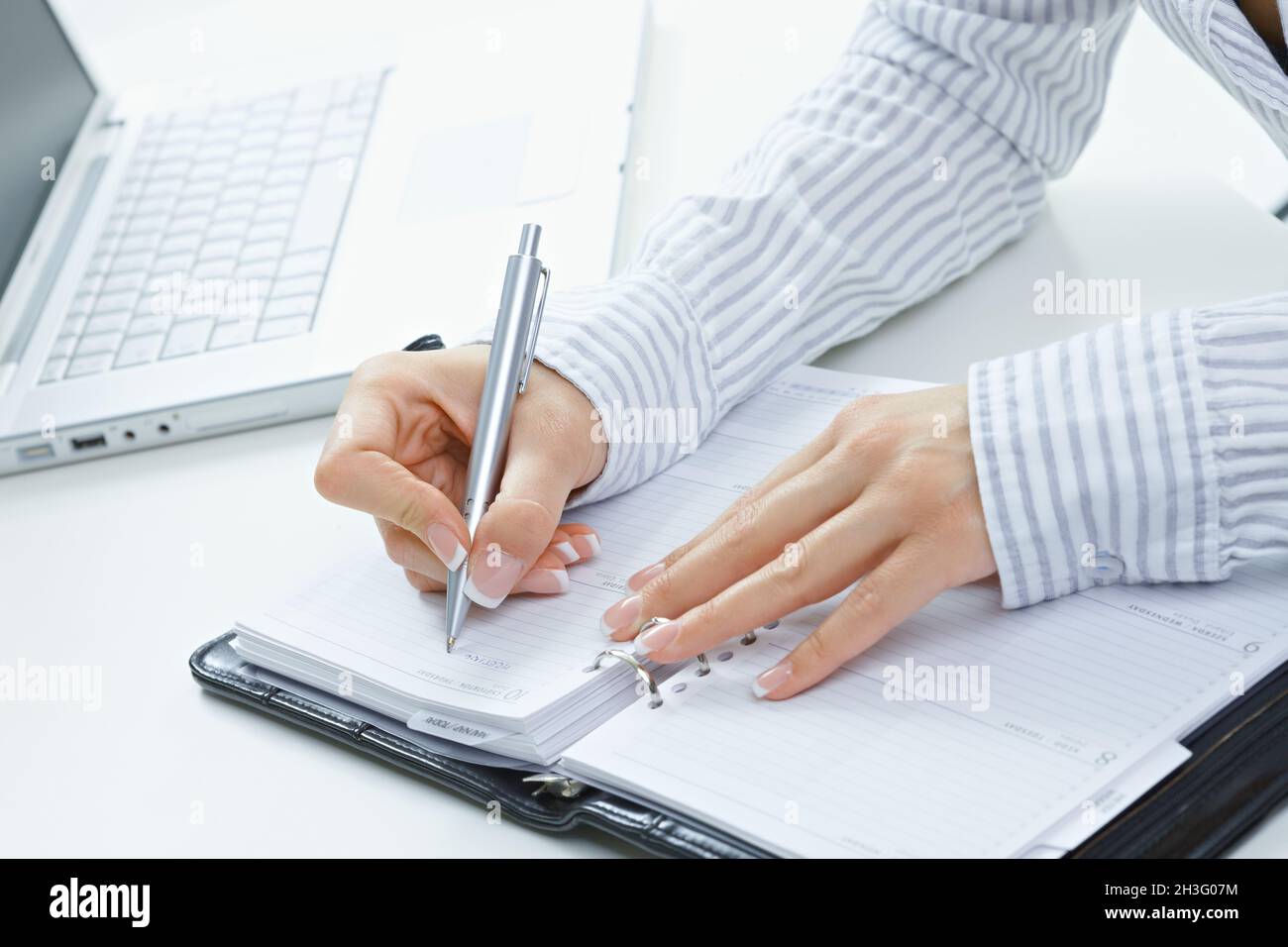 Female hand writing notes Stock Photo - Alamy