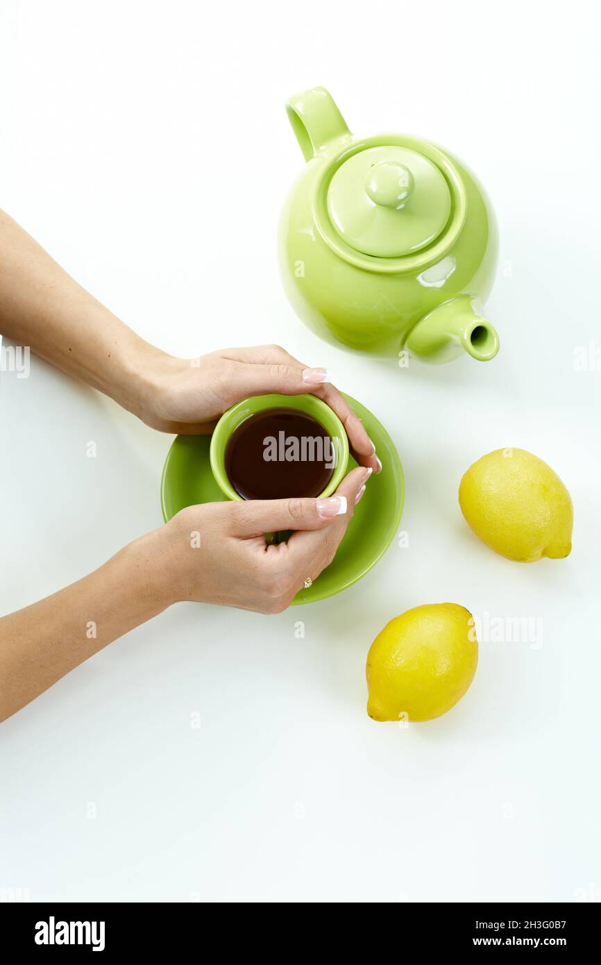 Female hands holding tea cup Stock Photo - Alamy