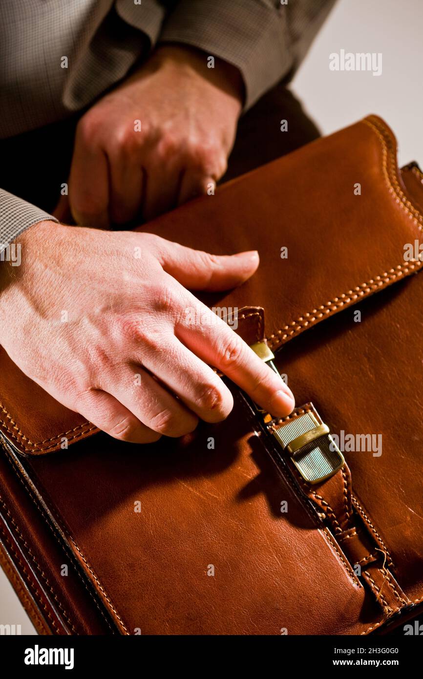 Hand opening briefcase Stock Photo - Alamy