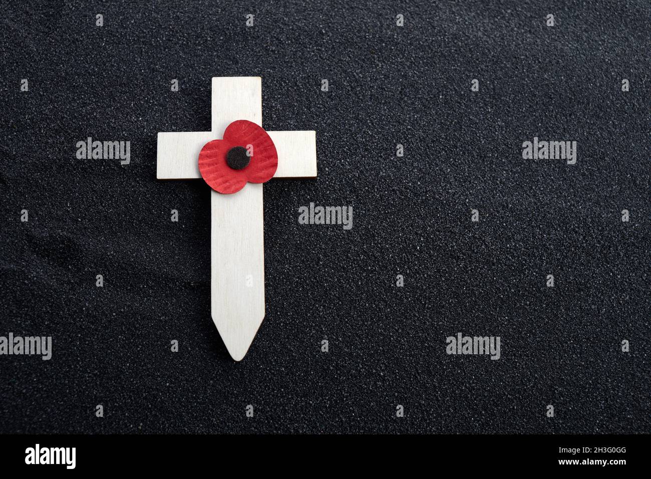 Remembrance Day poppy symbol on wooden cross. 11th November is a ...