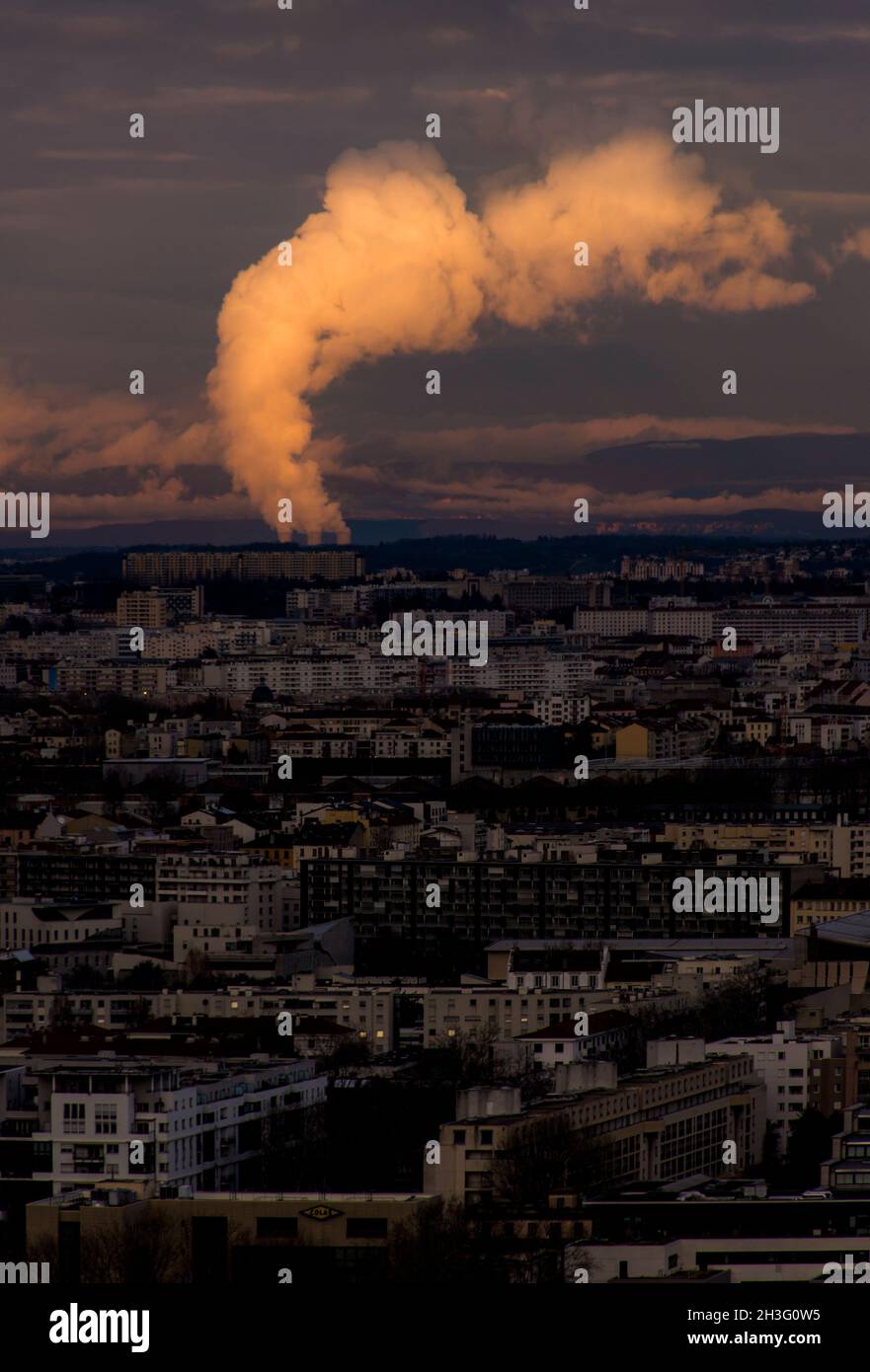 Big steam column from a nuclear plant at the afternoon in Lyon City ...