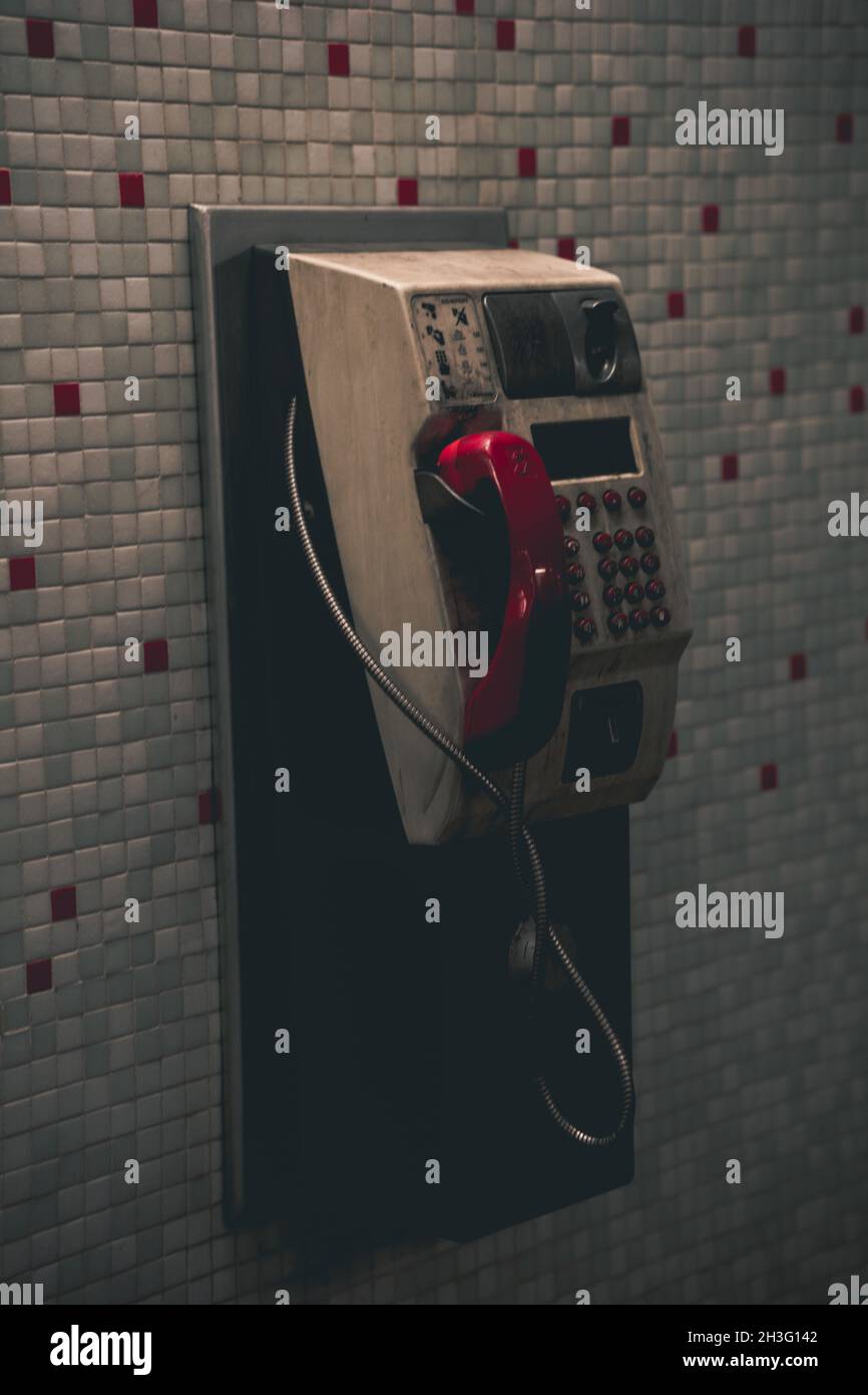 Vertical shot of an old wired telephone on the wall outdoors wi Stock ...