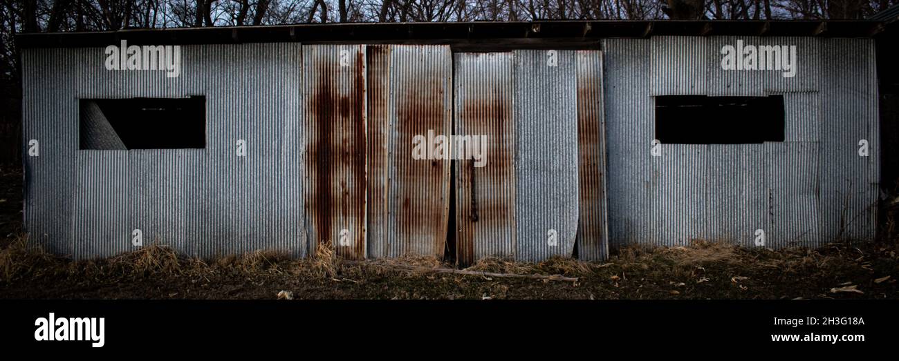 Panoramic shot of an old rusty garage in a forest in the daylight Stock ...