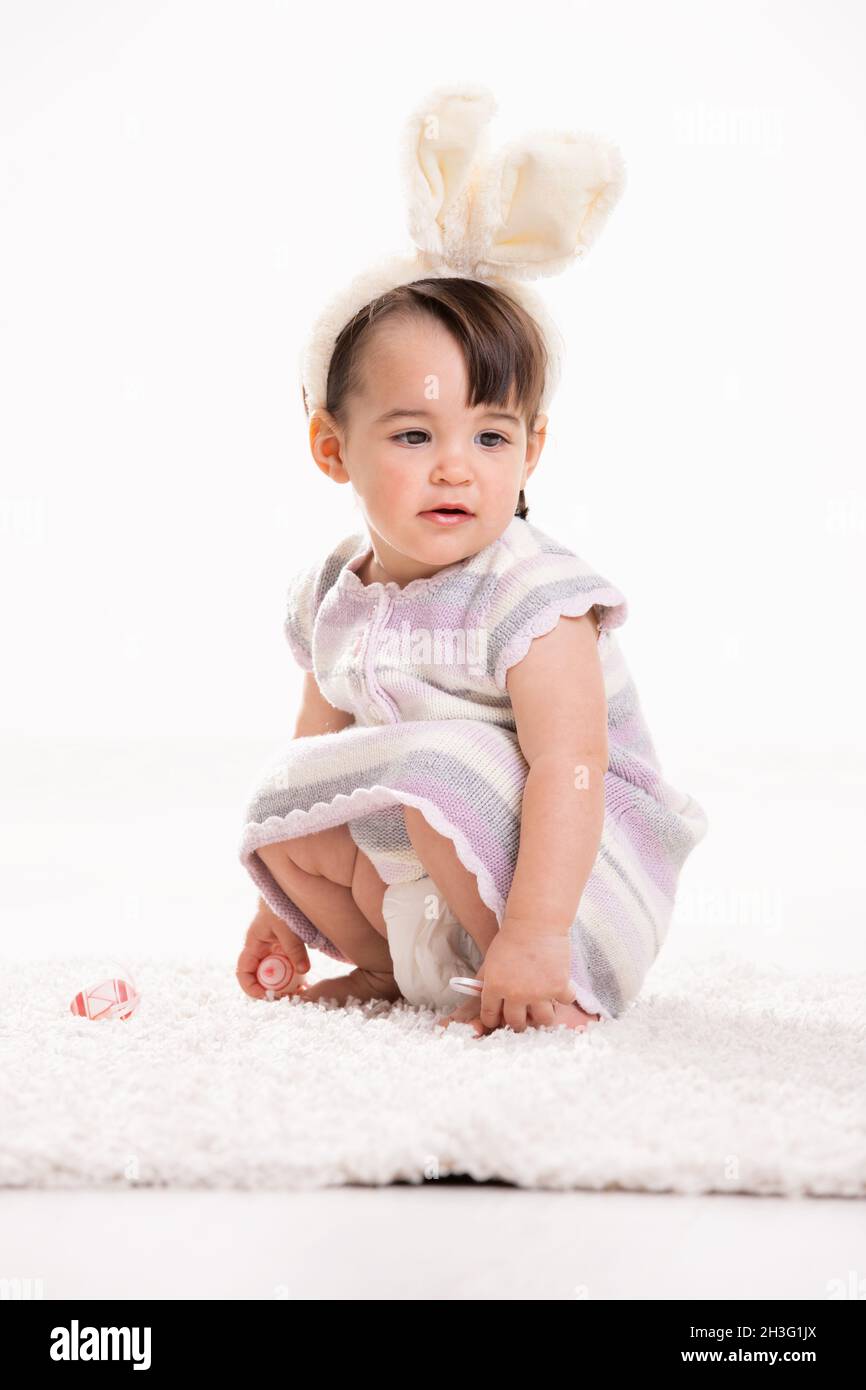 Little girl crouching on floor hi-res stock photography and images - Alamy