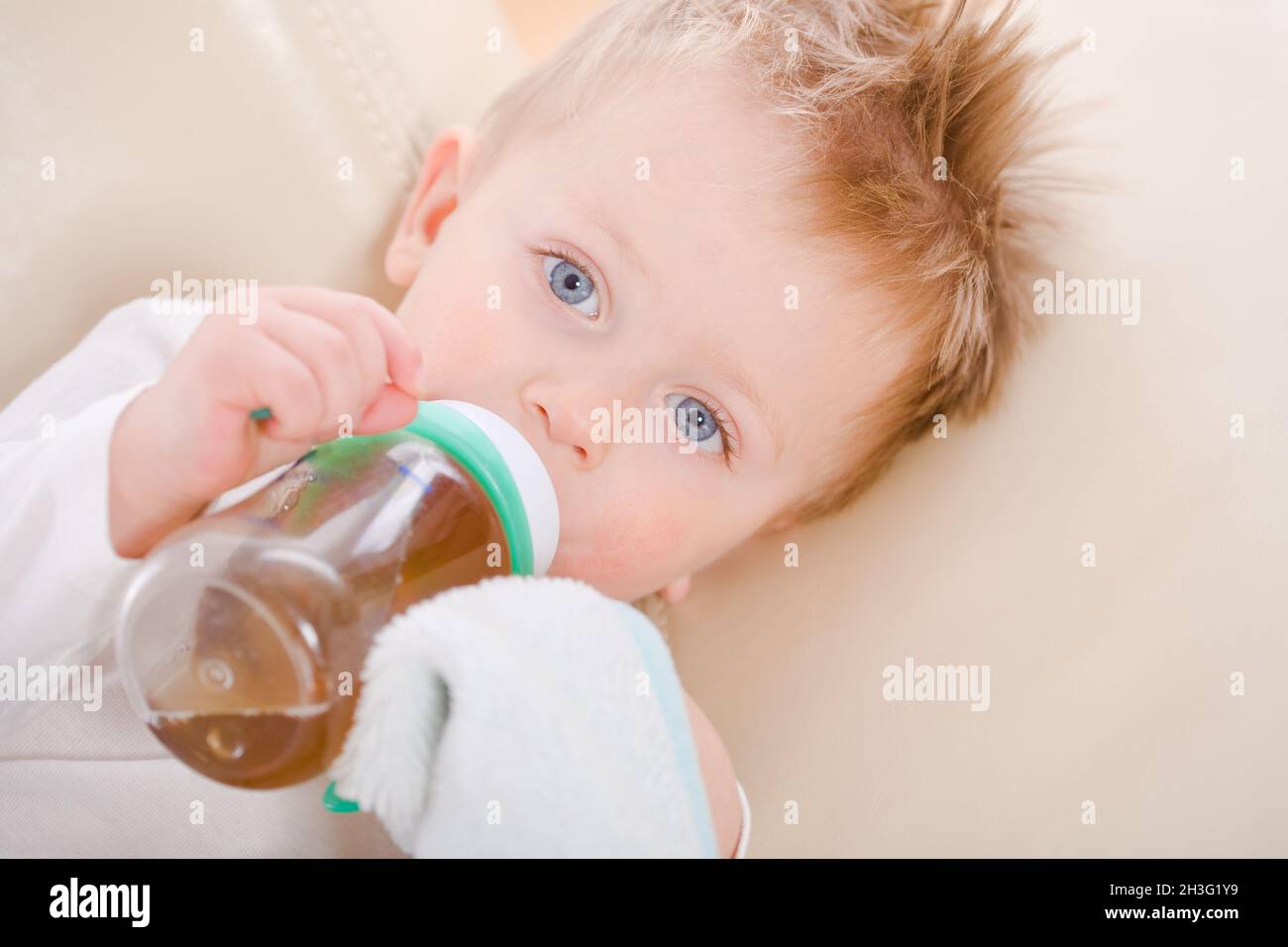 Baby boy drinking from bottle Stock Photo - Alamy