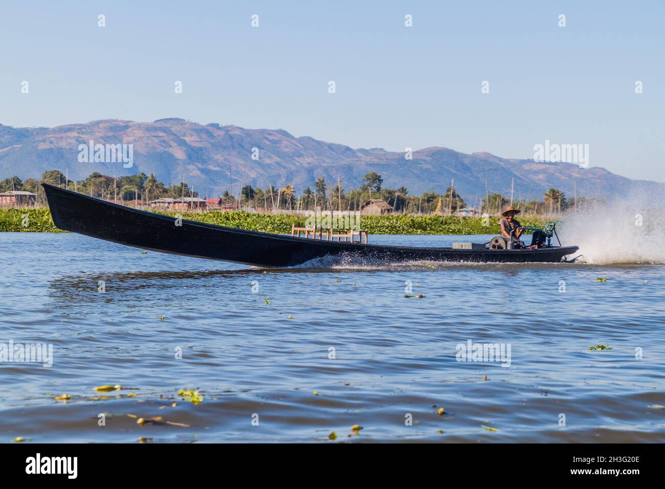 INLE, MYANMAR - NOVEMBER 26, 2016: Loacal man on a boat at Inle lake ...