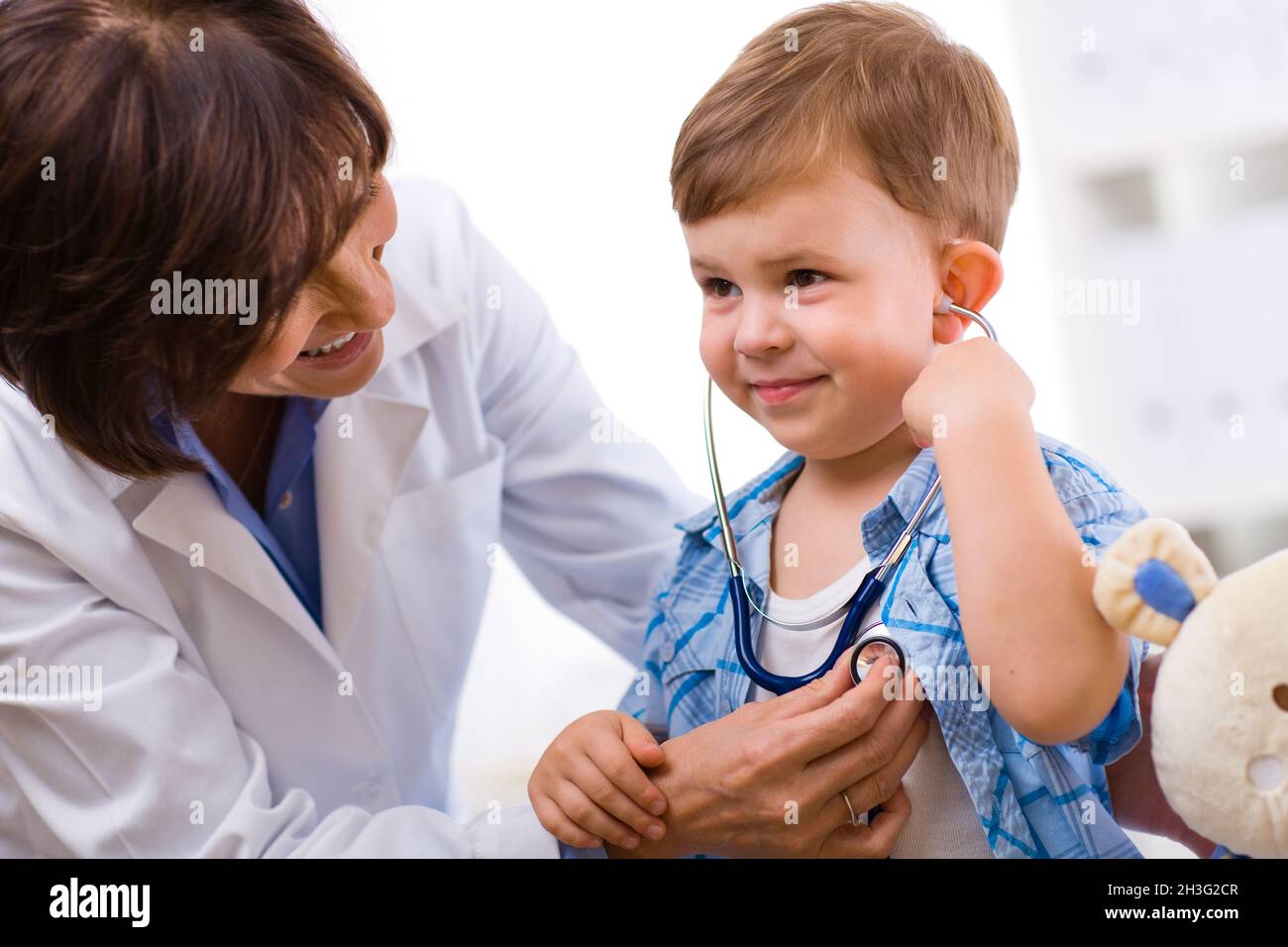 Doctor examining child Stock Photo - Alamy