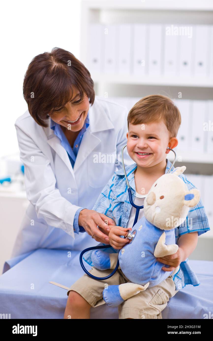 Doctor examining child Stock Photo - Alamy