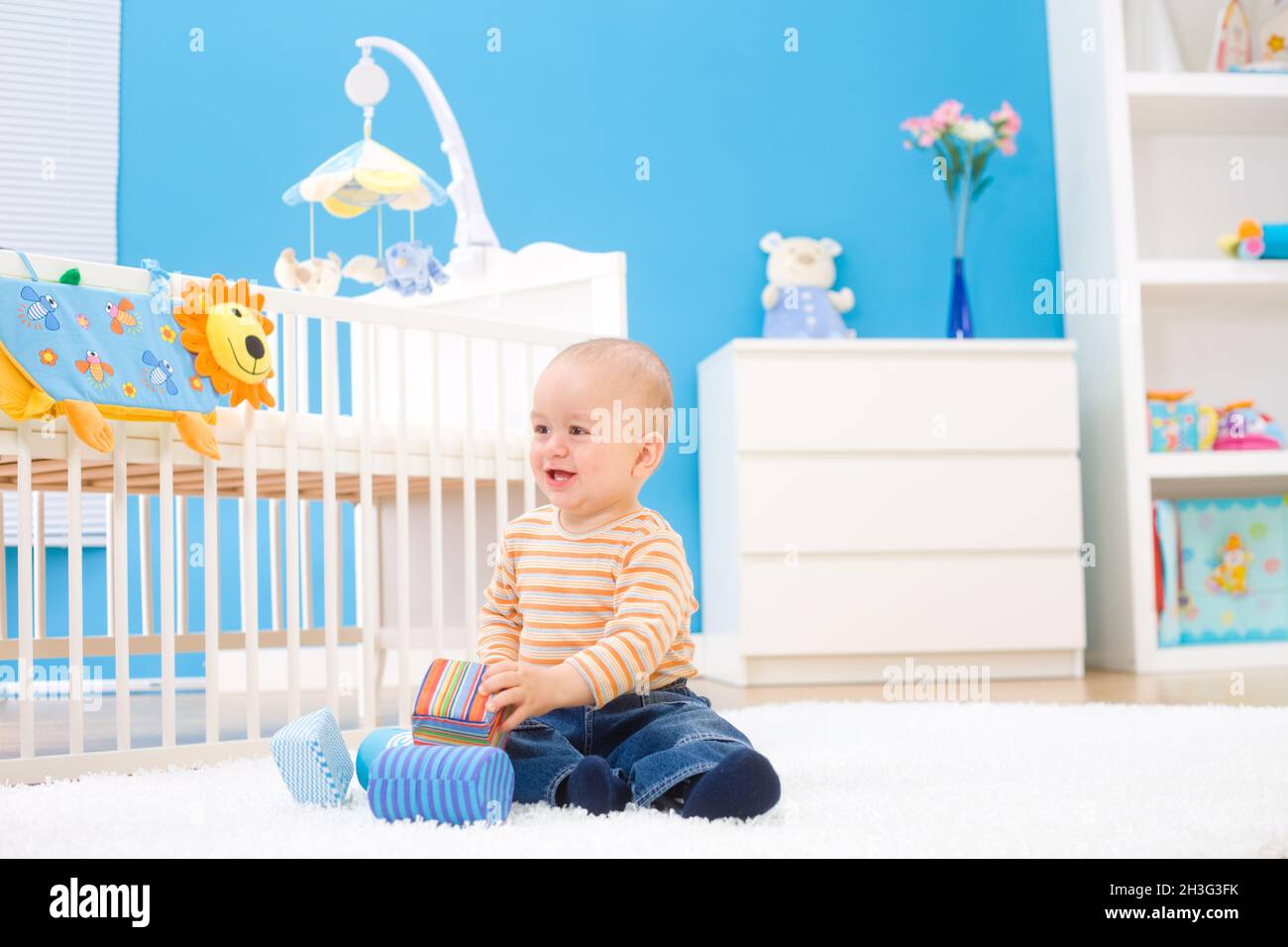 Happy baby playing indoor Stock Photo - Alamy