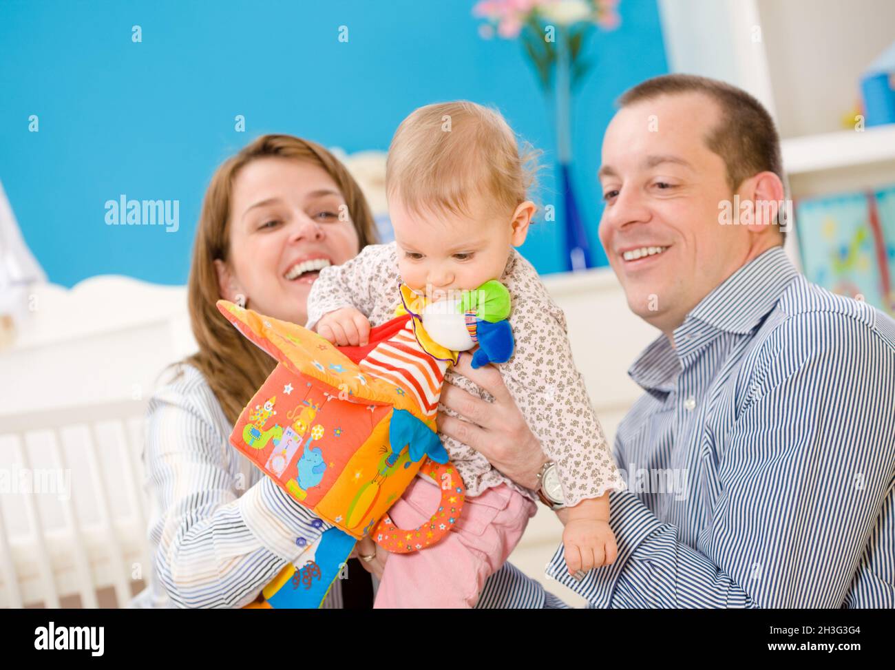 Happy family playing together Stock Photo - Alamy