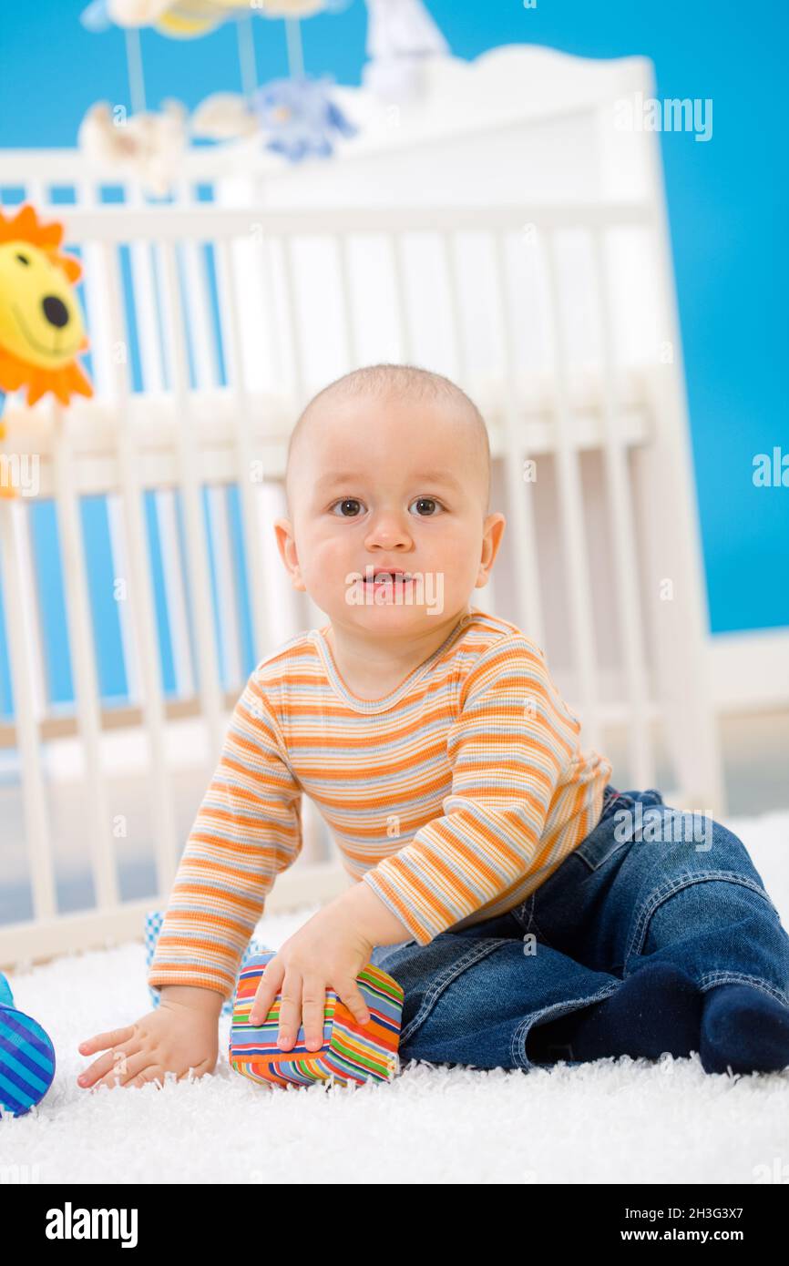 Baby playing at home Stock Photo - Alamy