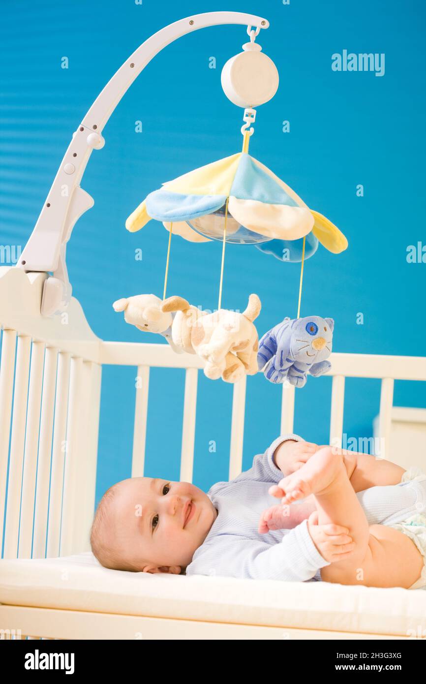 Baby on crib Stock Photo - Alamy