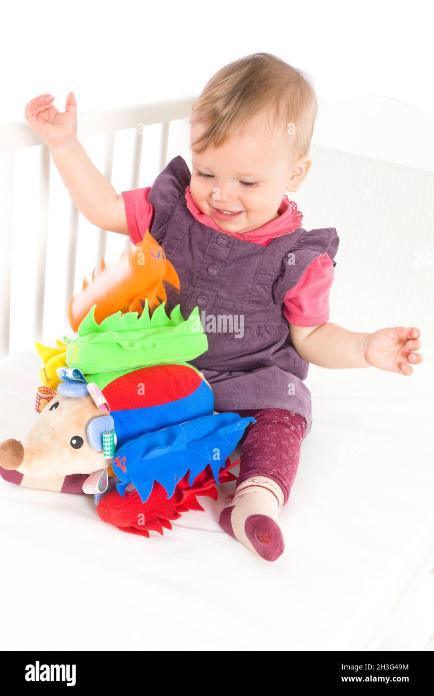 Baby playing with soft toy Stock Photo - Alamy