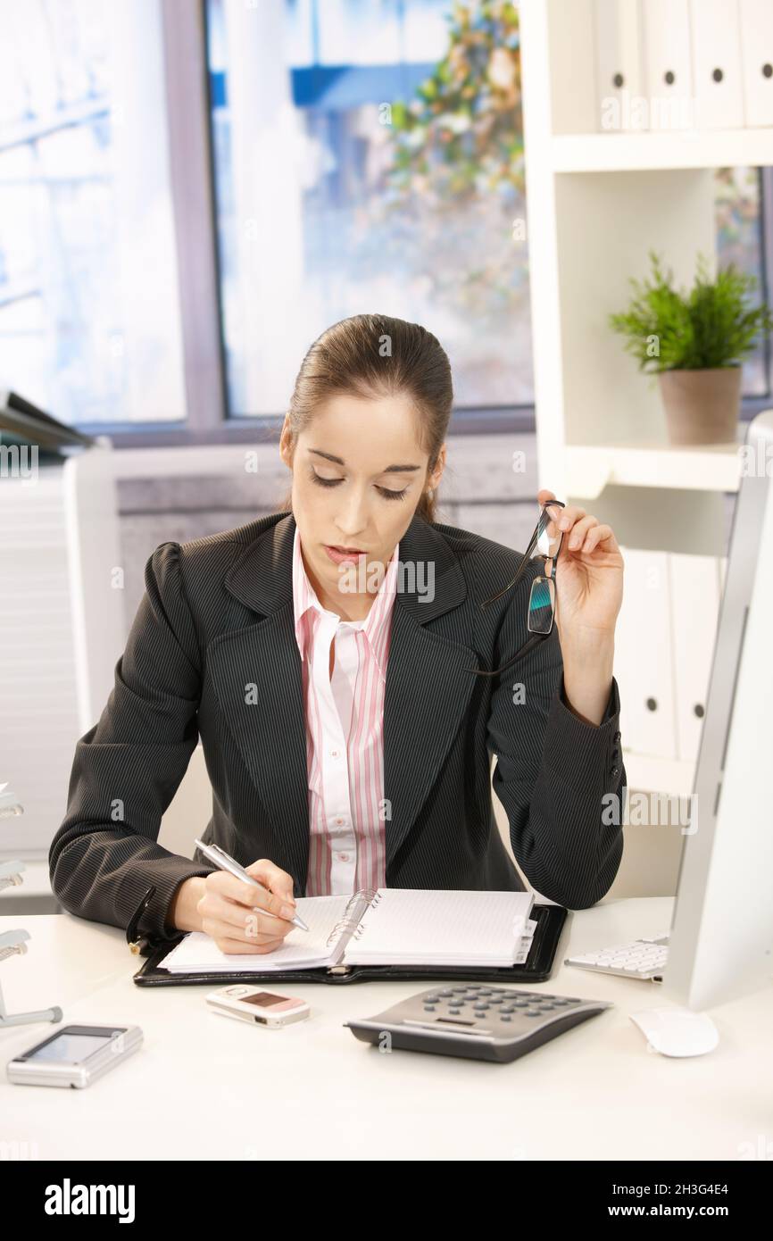 Businesswoman taking notes Stock Photo - Alamy