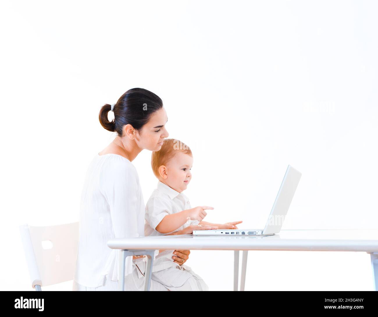 Mother and baby using laptop Stock Photo - Alamy