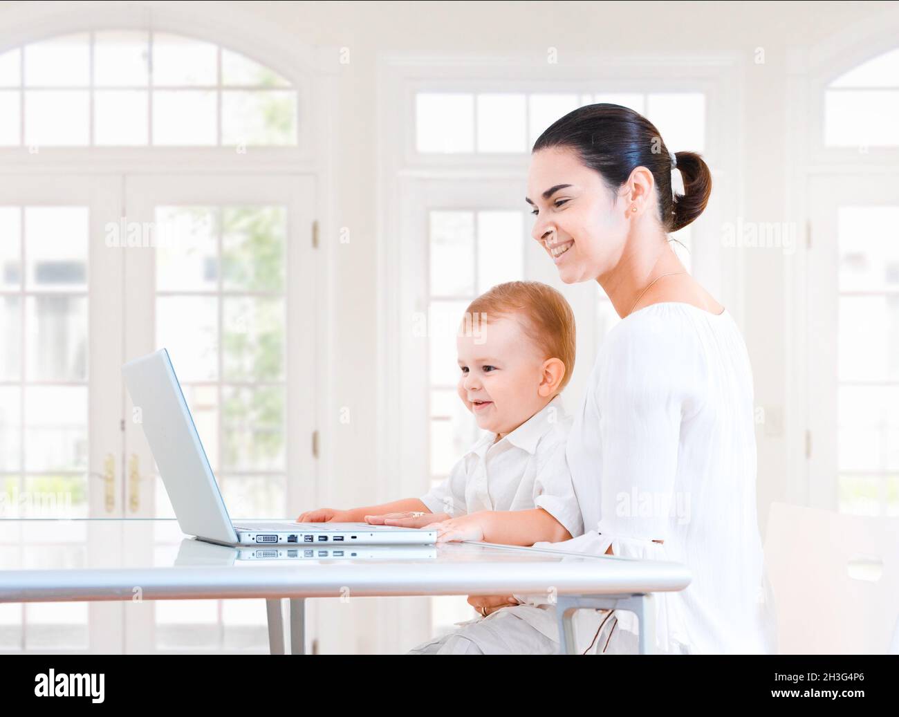 Mother and baby using laptop Stock Photo - Alamy
