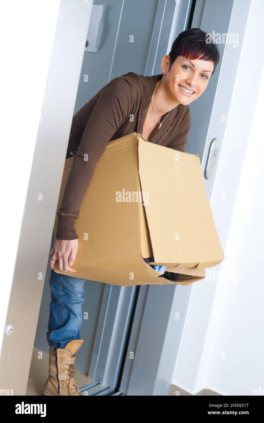 Woman carrying cardboard box Stock Photo - Alamy
