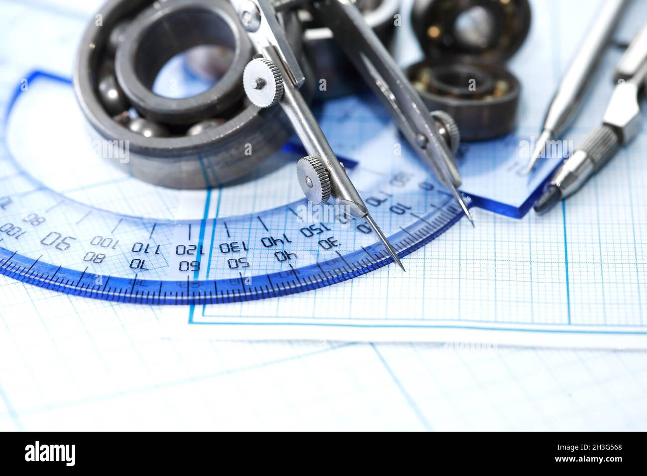 Set of old drawing tools on background with graph paper Stock Photo - Alamy