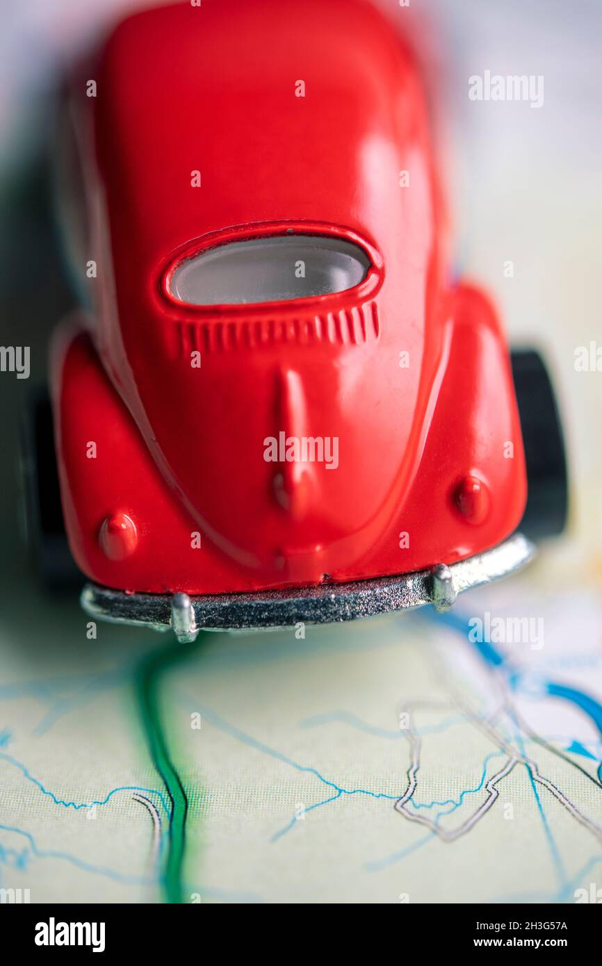 Red toy car on a road map Stock Photo - Alamy