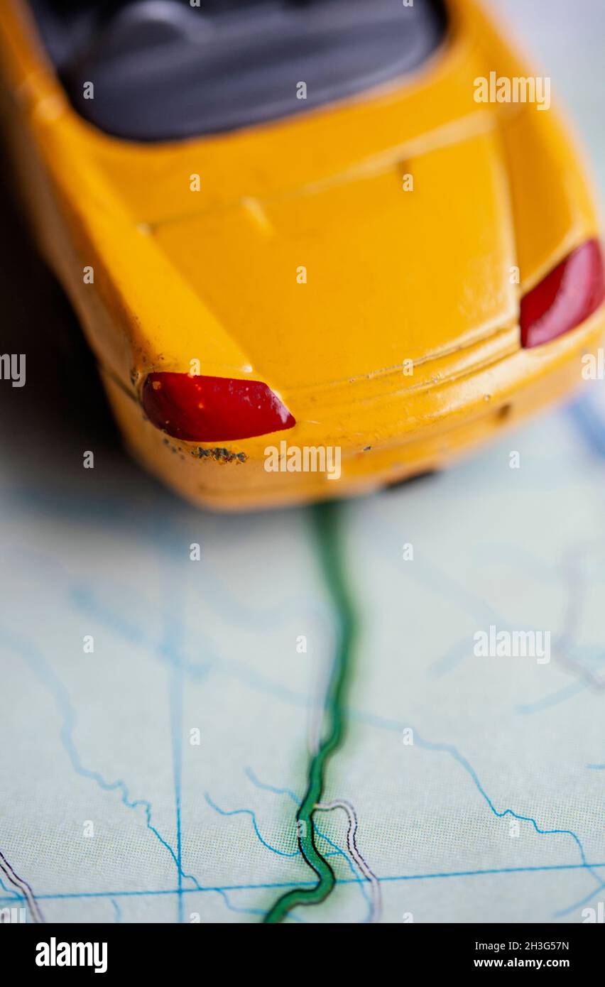 Toy car on a road map Stock Photo - Alamy