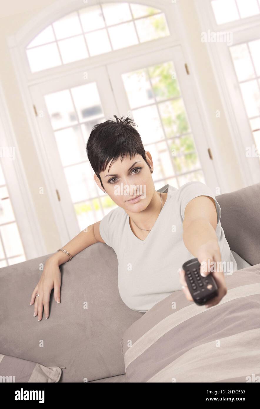 Young woman watching TV Stock Photo - Alamy