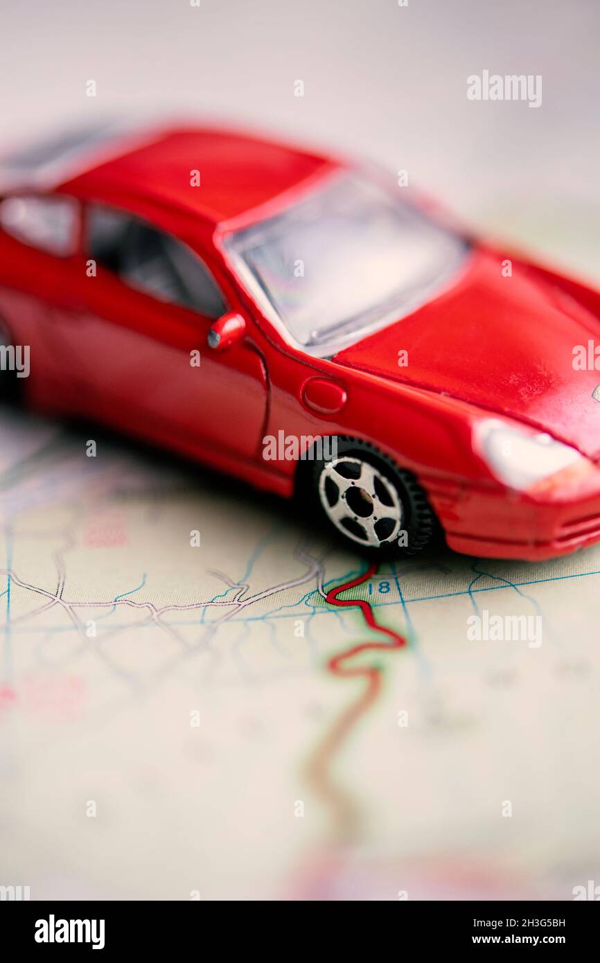 Red toy car on a road map Stock Photo - Alamy