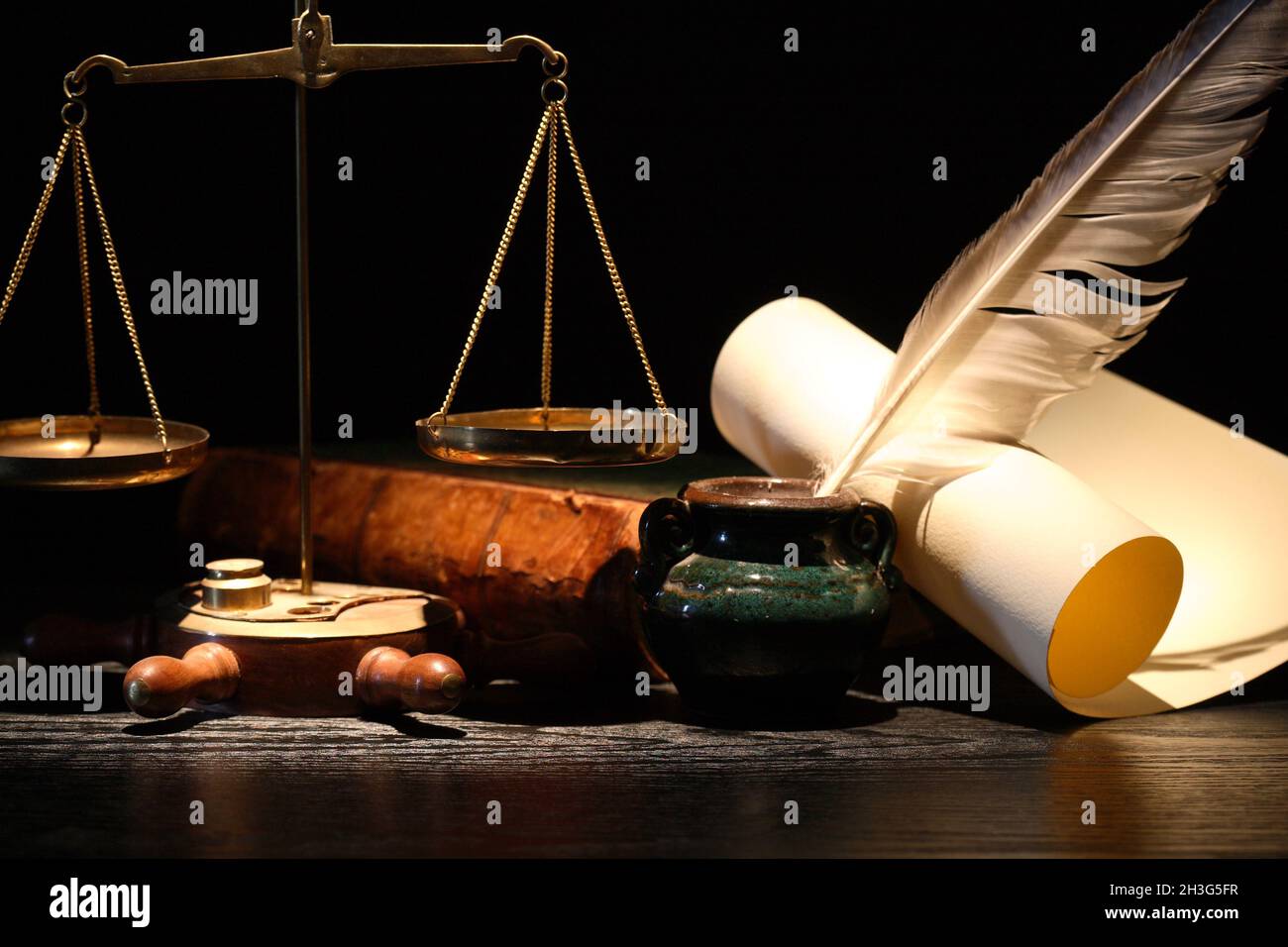 Justice or science concept. Weight scale near old book and quill pen on ...