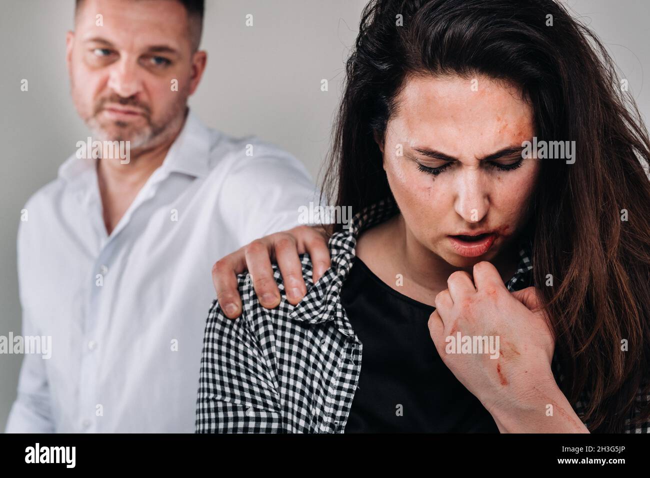 the male rapist put his hand on the shoulder of the beaten woman on a ...