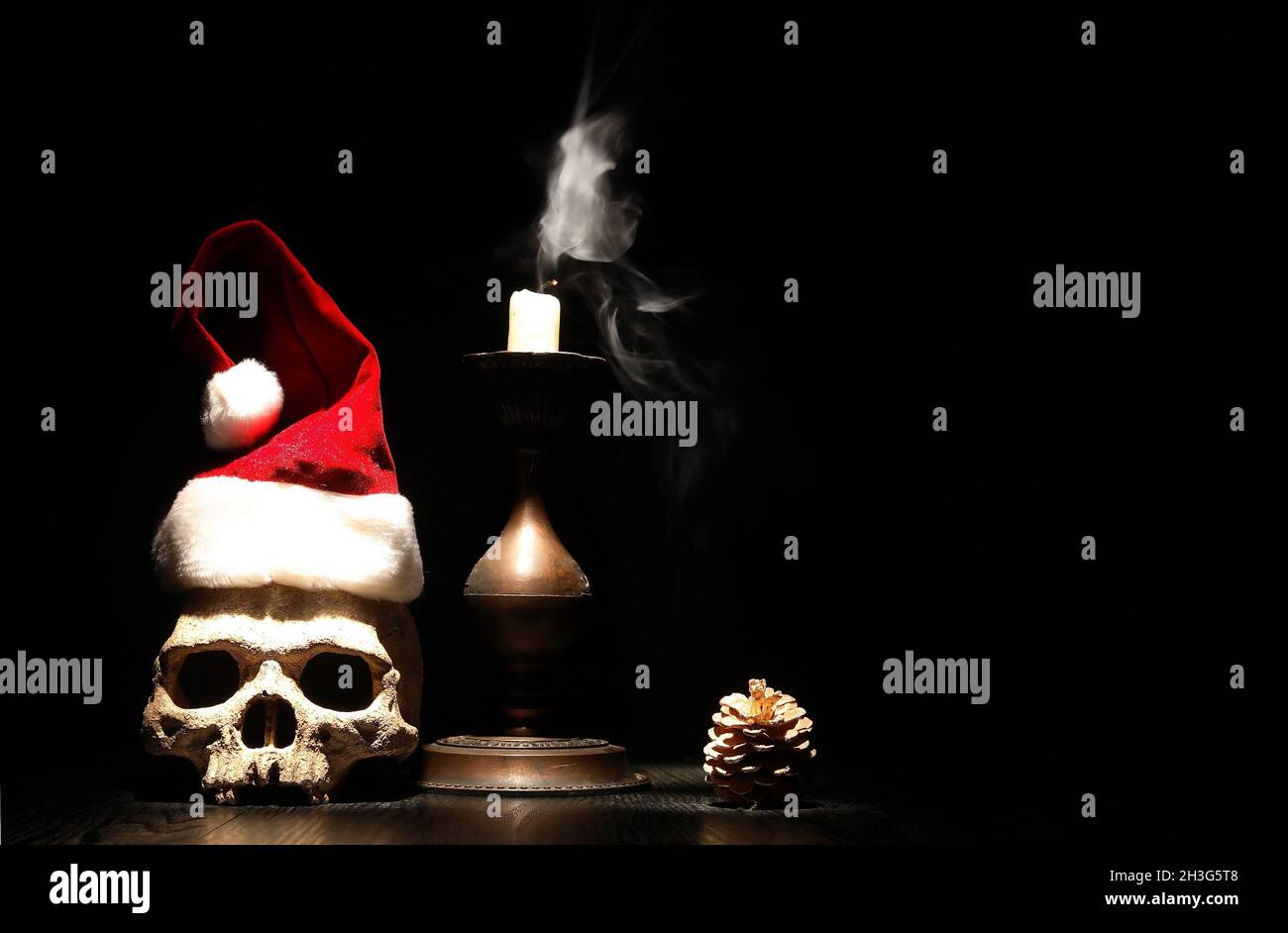 The death of Santa Claus. Human skull with Christmas hat near ...