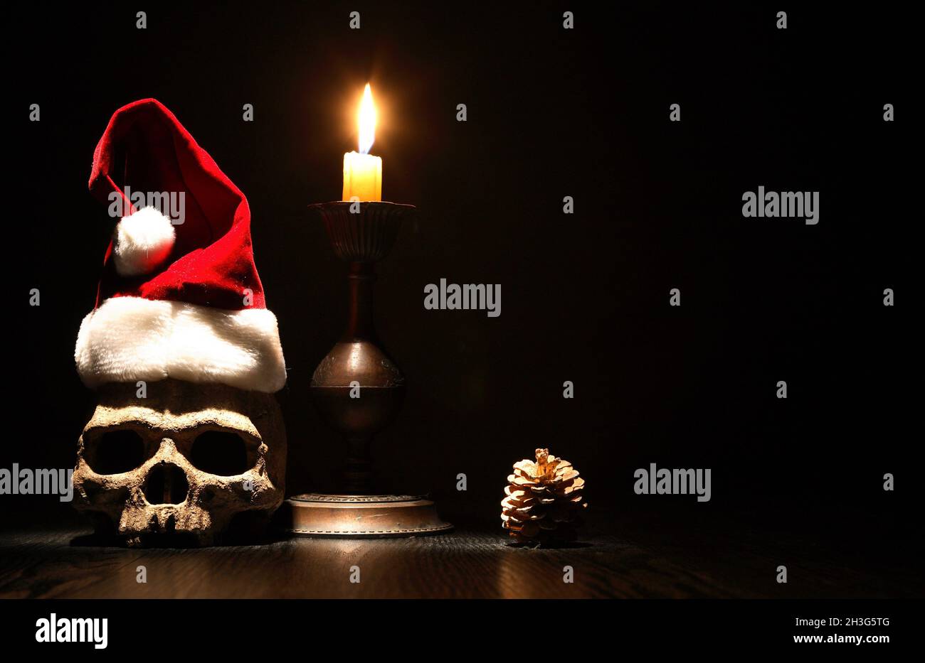 The death of Santa Claus. Human skull with Christmas hat near lighting ...