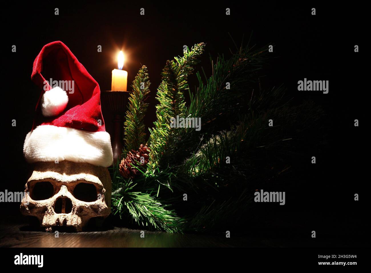 The death of Santa Claus. Human skull with Christmas hat near lighting ...
