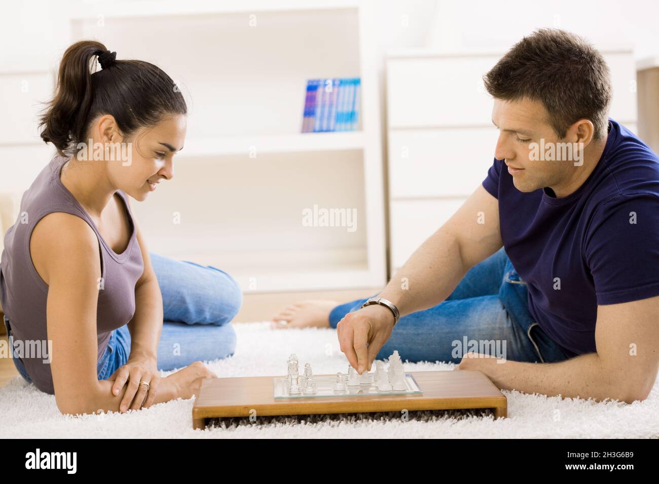 Couple playing chess Stock Photo - Alamy