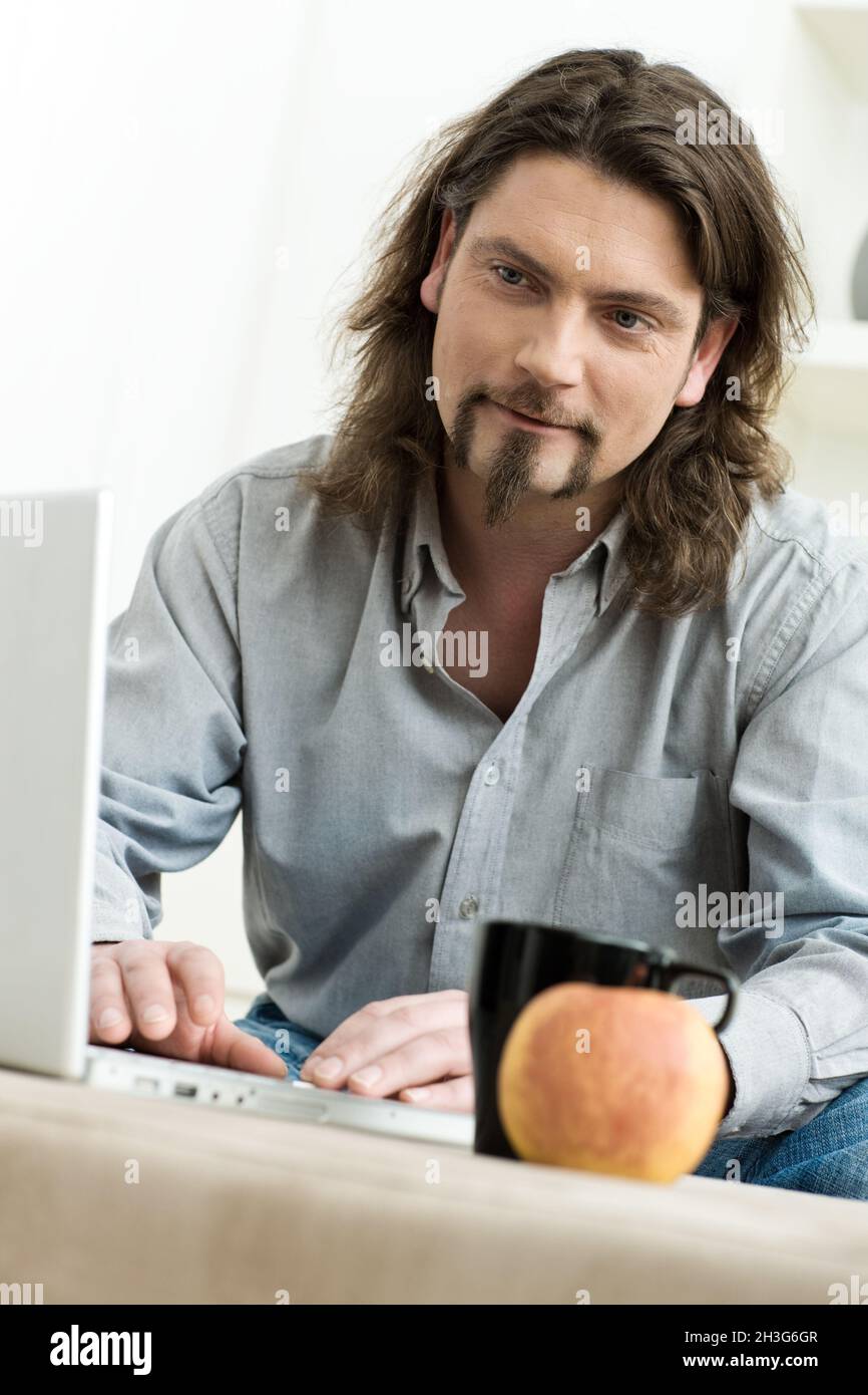 Man using laptop computer Stock Photo - Alamy