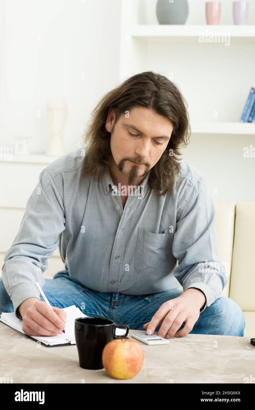 Man writing notes Stock Photo - Alamy