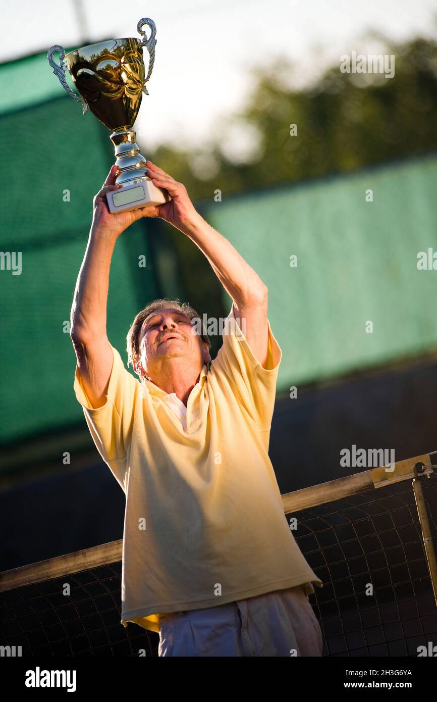 Senior man offering cup hi-res stock photography and images - Alamy
