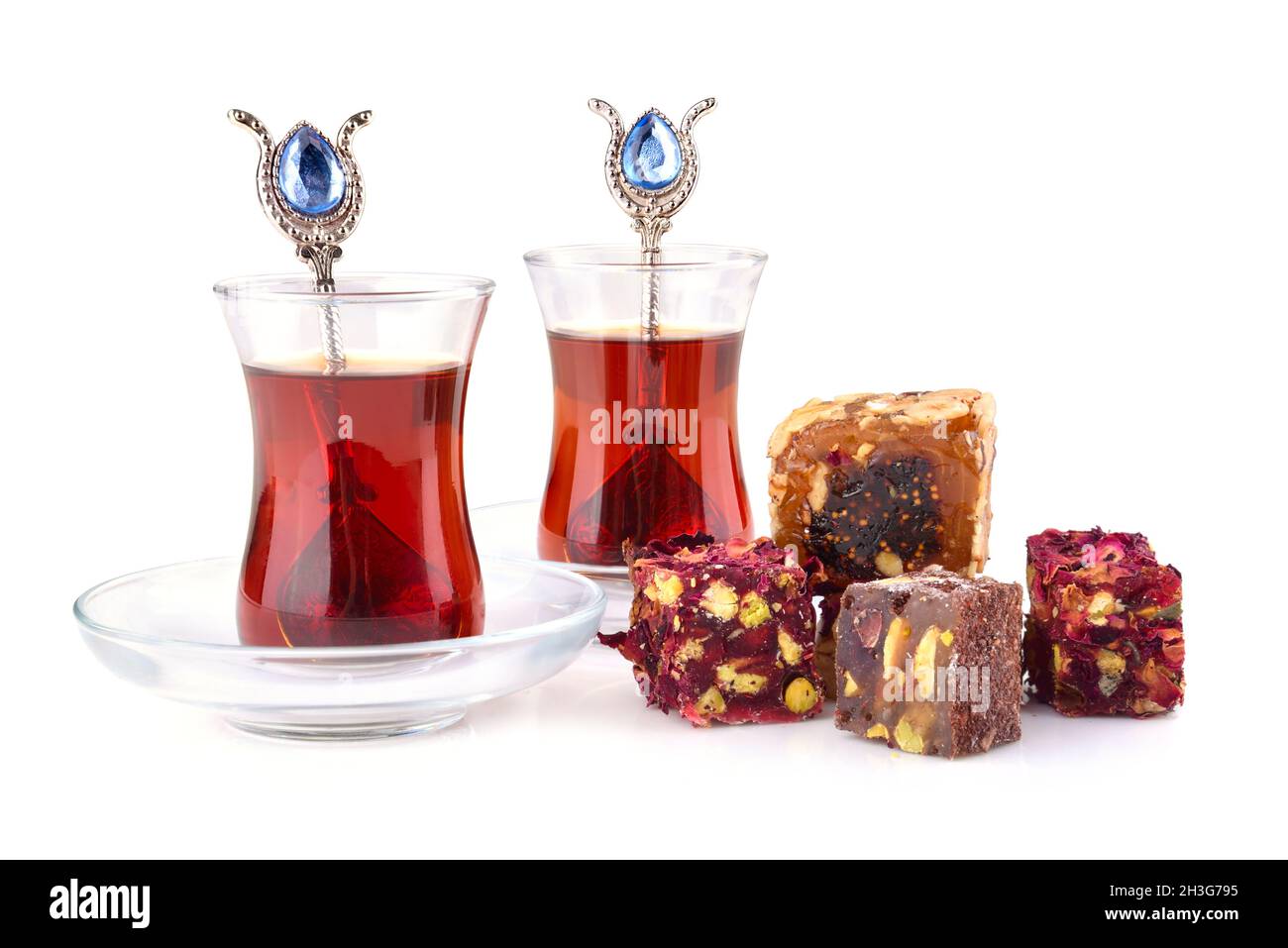 Traditional turkish delight rahat lokum with two glasses of tea on a ...