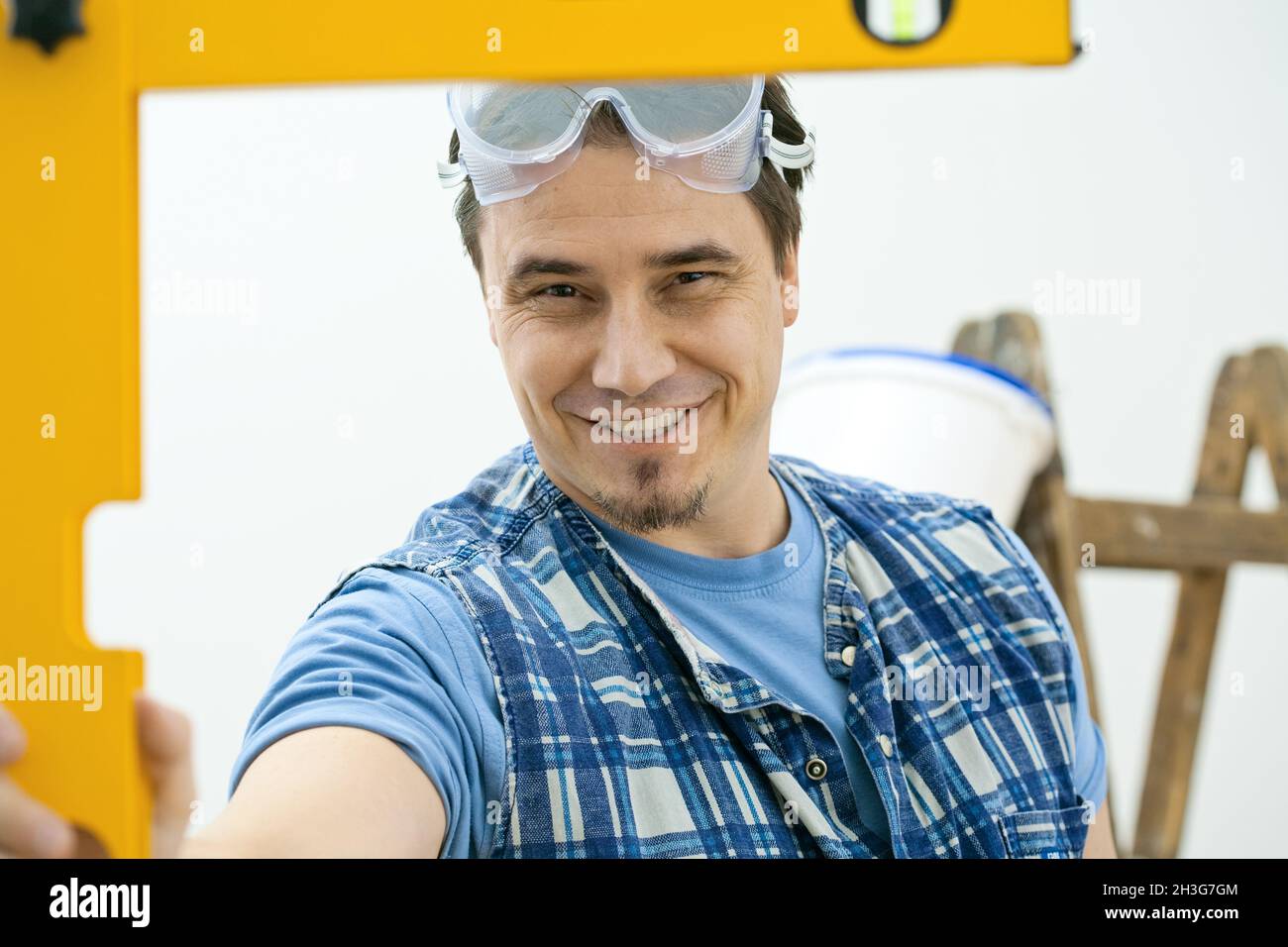 Worker using level tool Stock Photo - Alamy