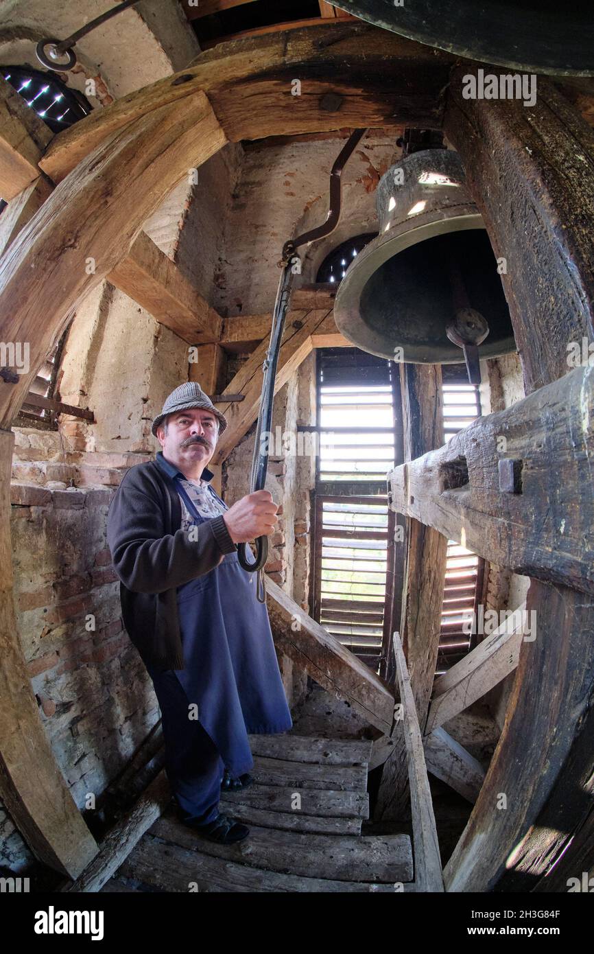 Middle-aged man wit moustache ringing the bells in church tower Stock ...