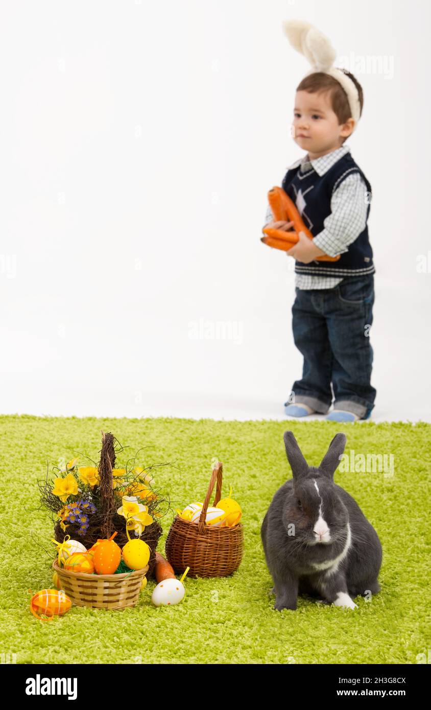 Little children playing with Easter bunny Stock Photo - Alamy