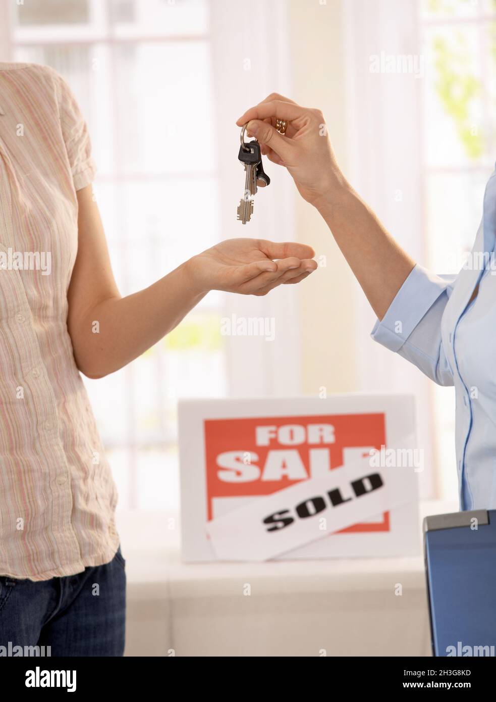 Getting keys to new house Stock Photo - Alamy