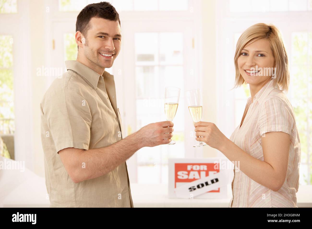 Couple celebrating new house Stock Photo - Alamy