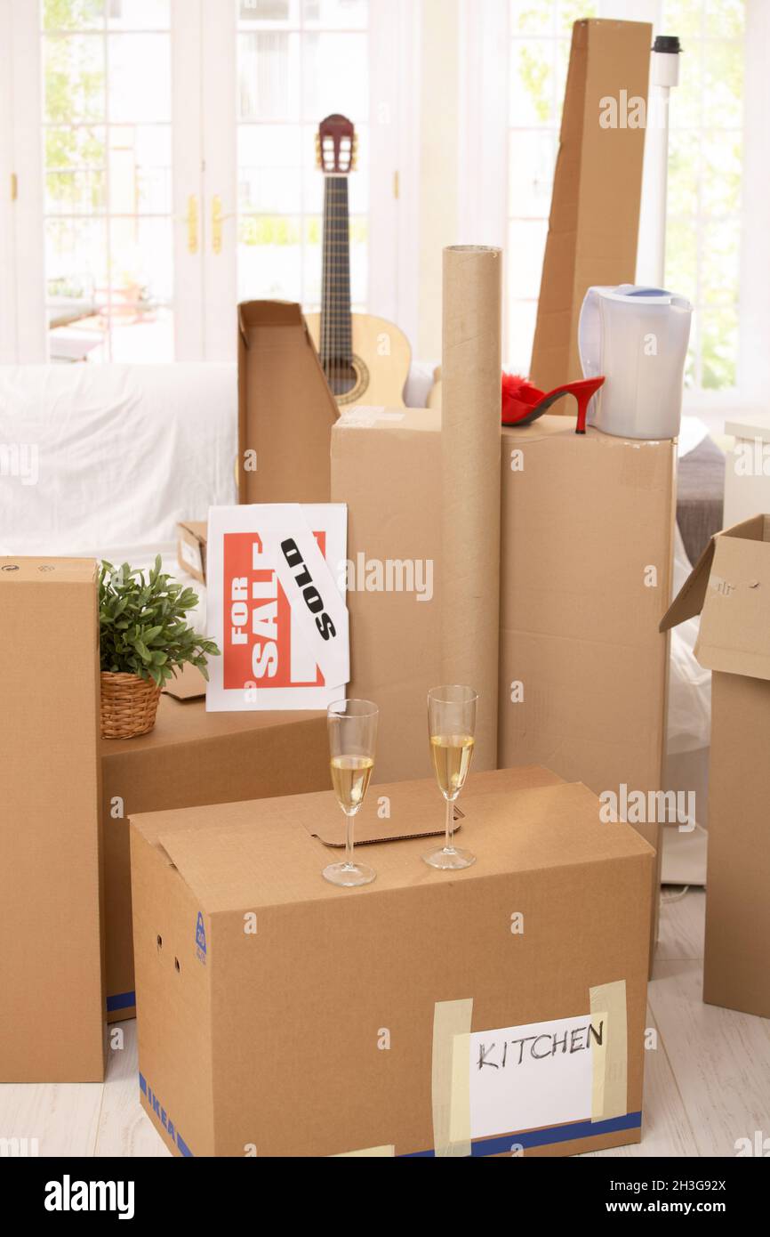 Pile of boxes and champagne in new house Stock Photo - Alamy