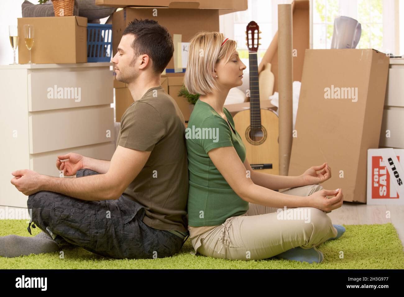Photo young couple meditating hi-res stock photography and images - Alamy