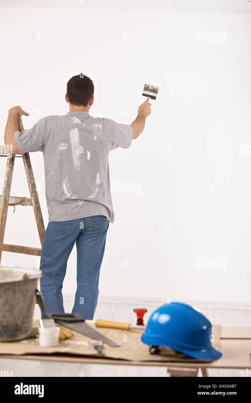 Guy painting wall Stock Photo - Alamy