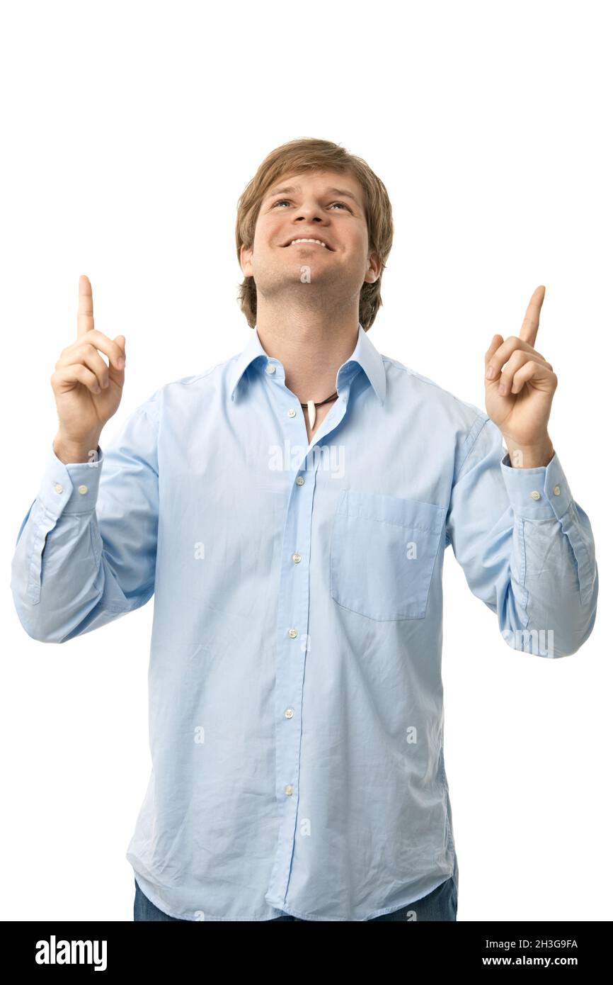 Casual young man pointing up Stock Photo - Alamy