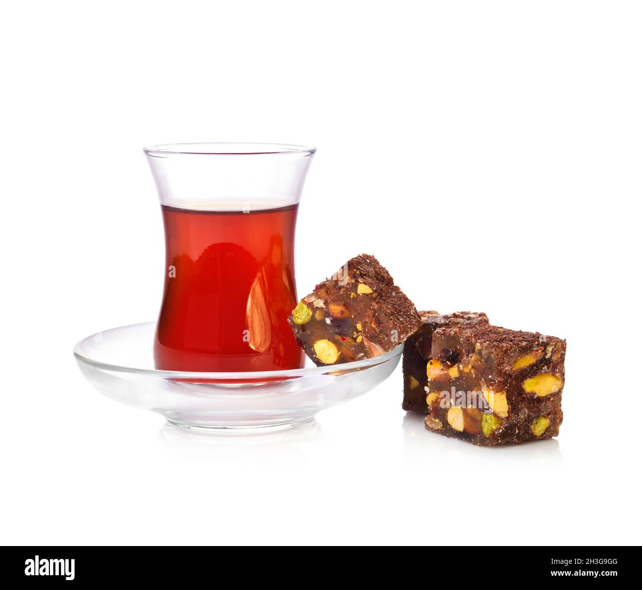 Traditional turkish delight rahat lokum with glass of tea on a white ...